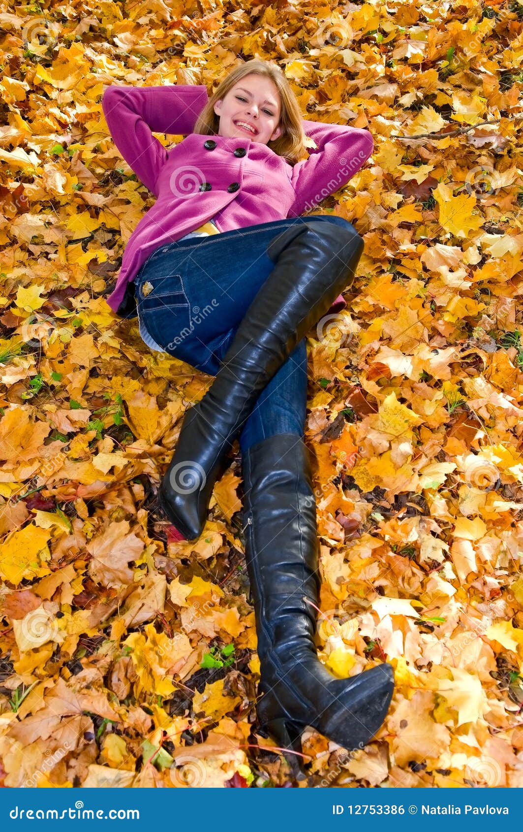 Young Smiling Woman on the Ground Stock Photo - Image of scarf, maple ...