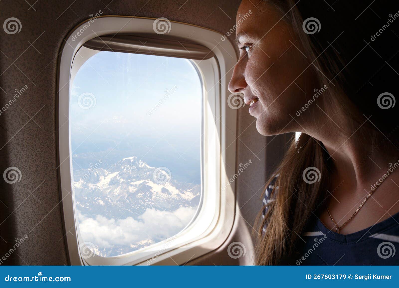 Young Smiling Woman Looking through the Plane Window on the Alps ...