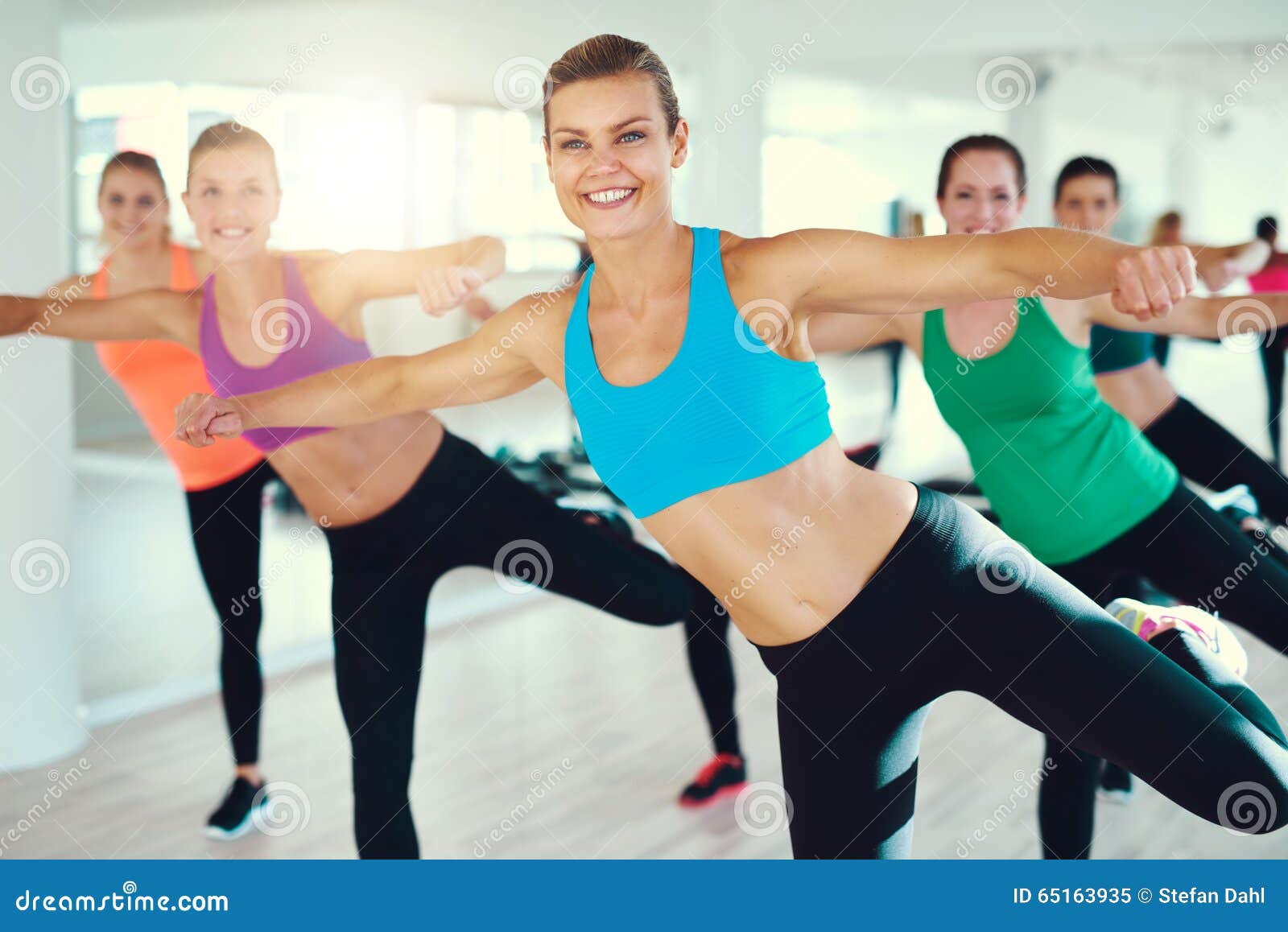 Young Smiling Women Doing Exercise Together Stock Image - Image of ...