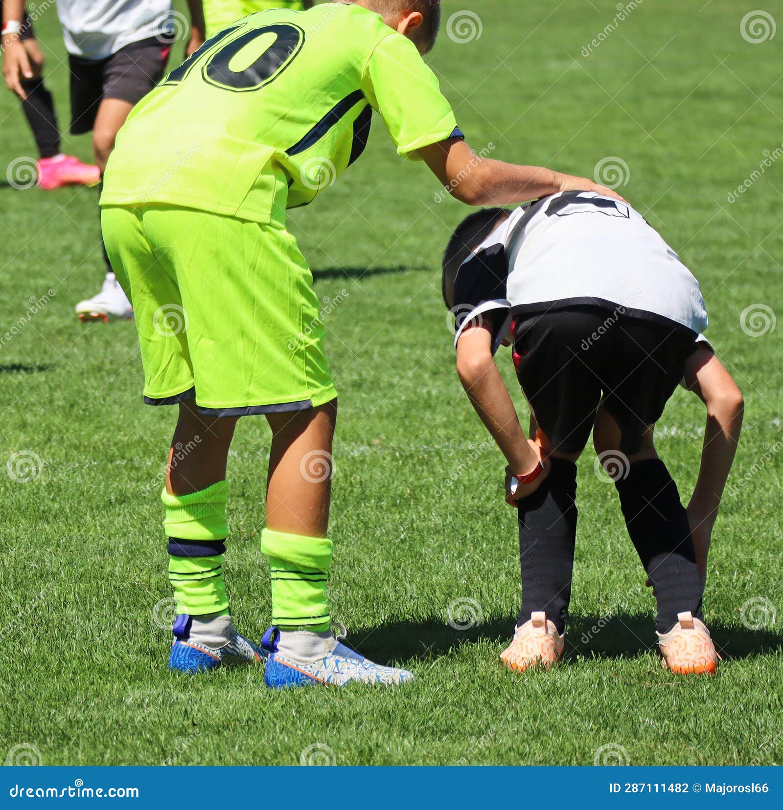 Young Soccer Player Helps To Stand Up a Fallen Player Stock Photo ...