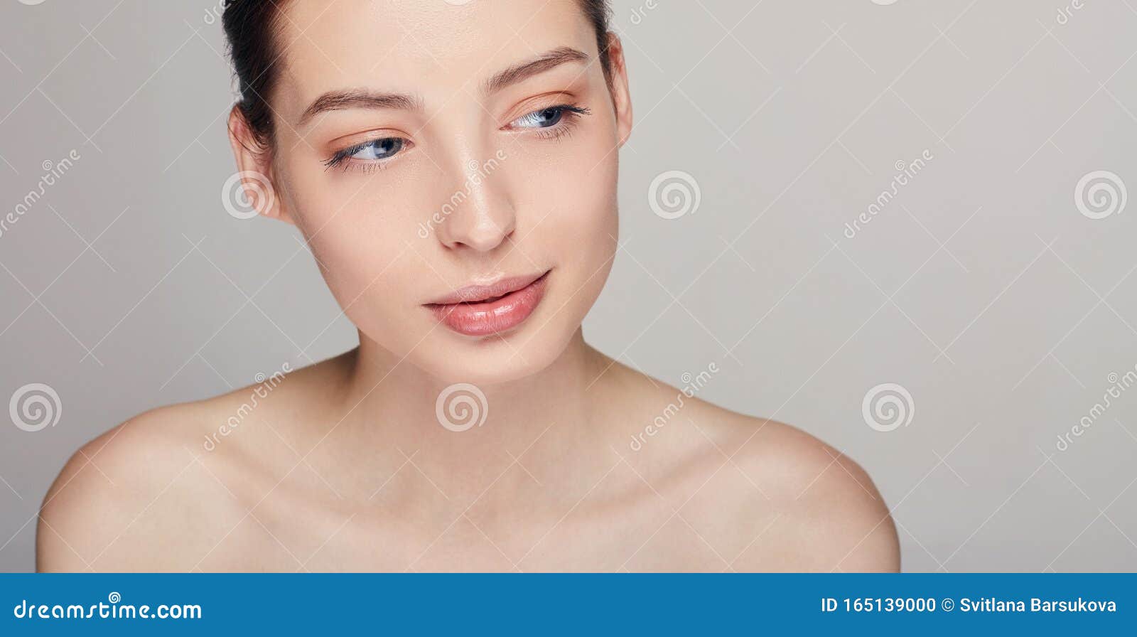 Young Sophisticated Girl With Blue Eyes And Full Lips With A Slight