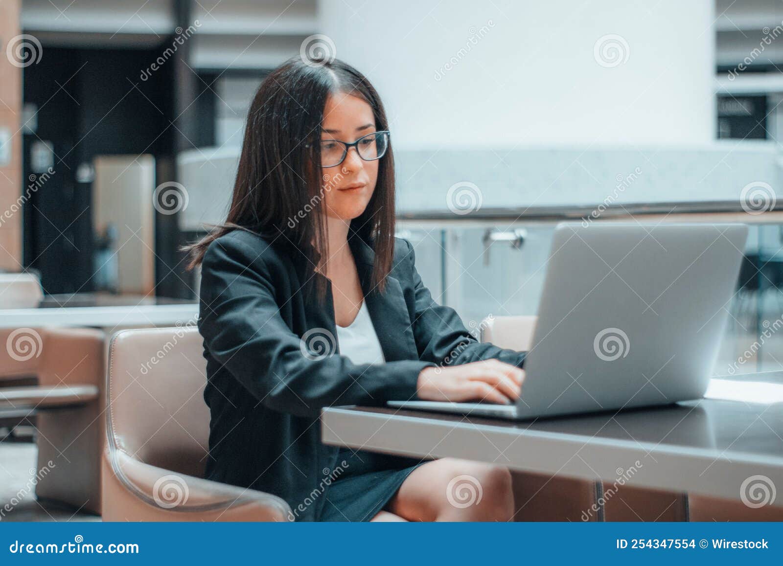 Young Spanish Woman Working on a Laptop Stock Photo - Image of online ...