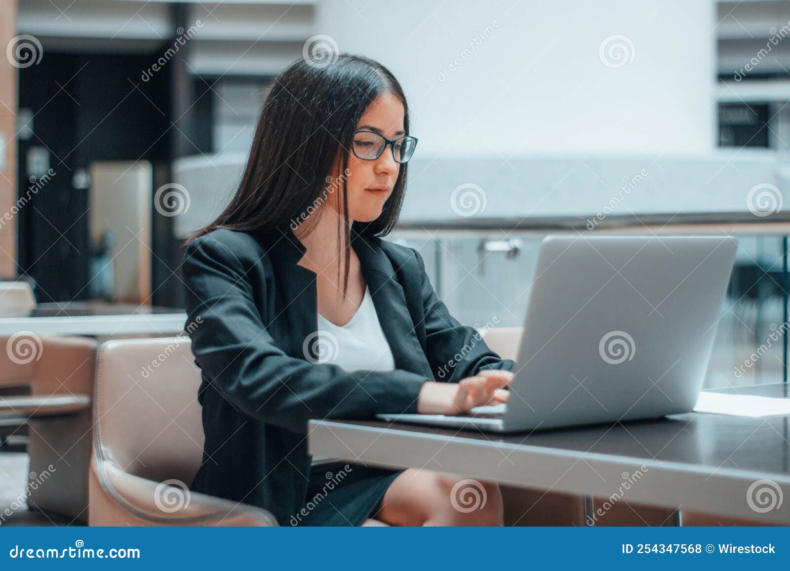 Young Spanish Woman Working on a Laptop Stock Photo - Image of spanish ...