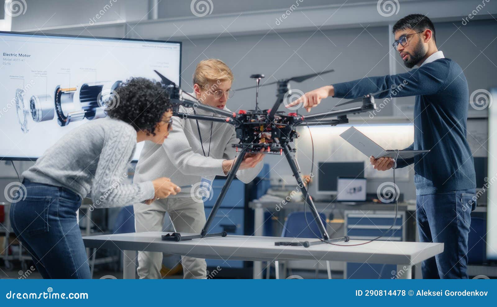 Young Specialists Connecting Drone To a Laptop. Engineers Try To Make ...
