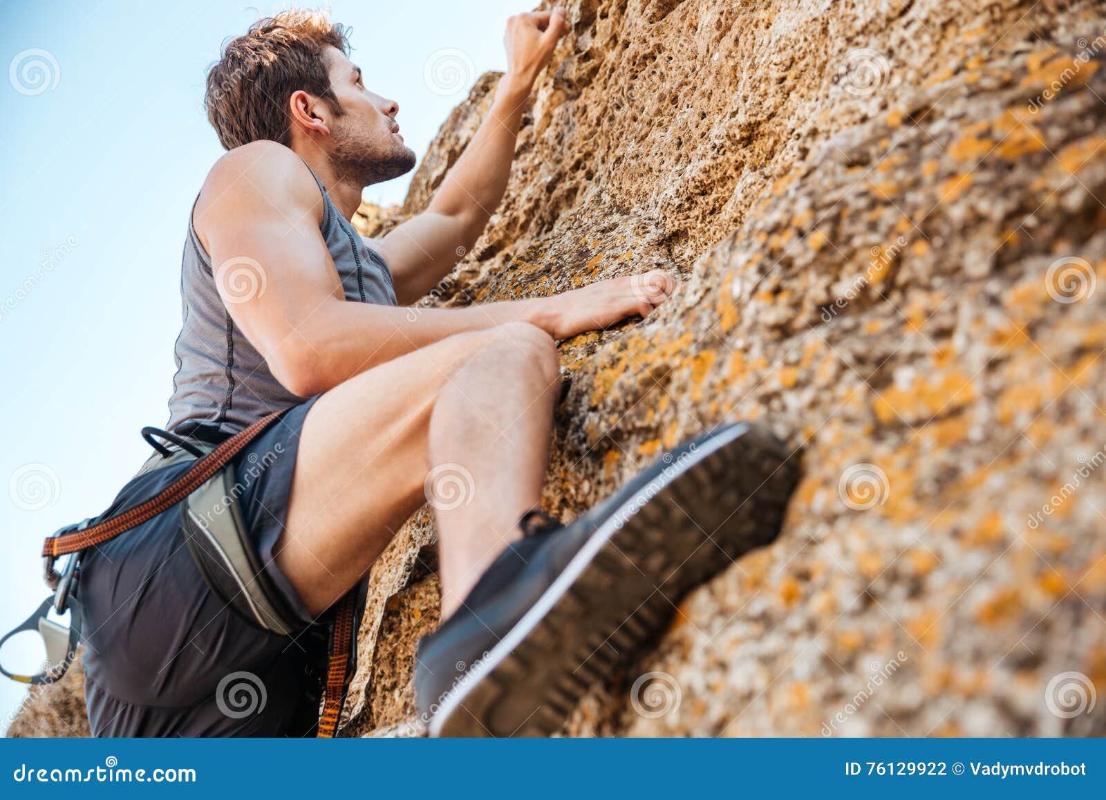 Young Sportsman Climbing Up a Rock Cliff Stock Photo - Image of adult ...
