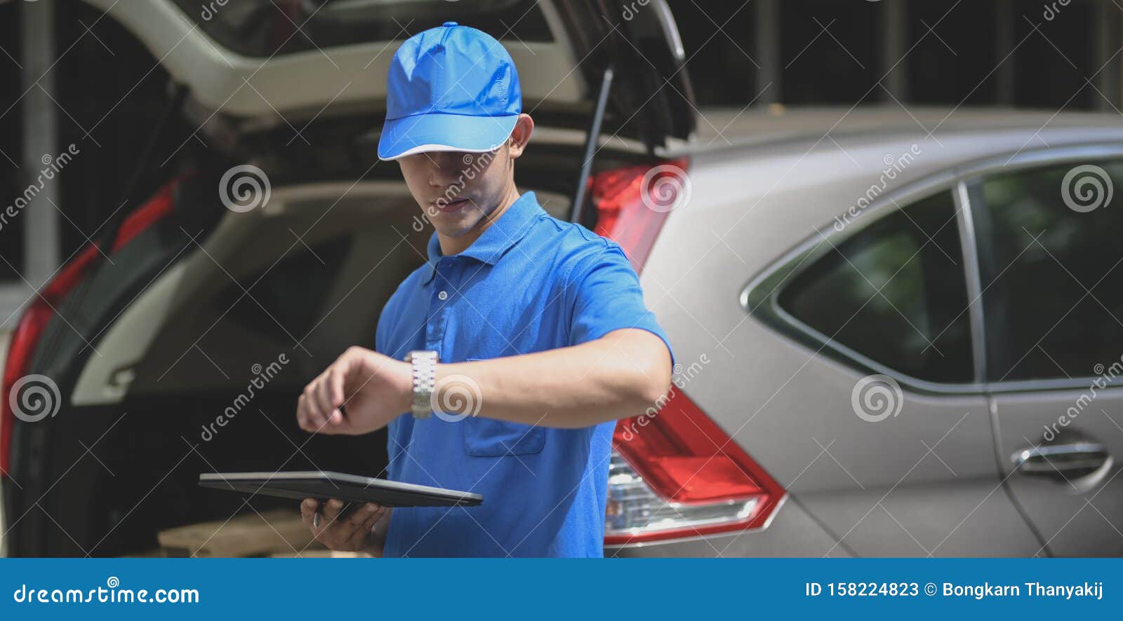 Young Startup Man Checking the Time and Preparing Orders for Customers ...