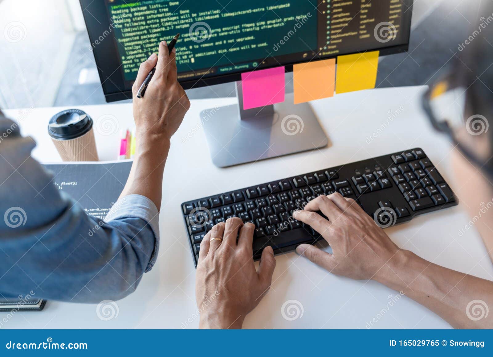 Young Startup Programmers Sitting at Desks Working on Computers Screen ...