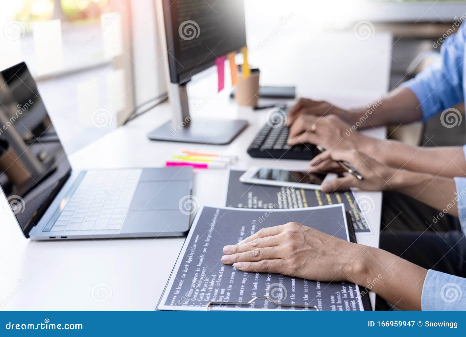 Young Startup Programmers Sitting at Desks Working on Computers Screen ...