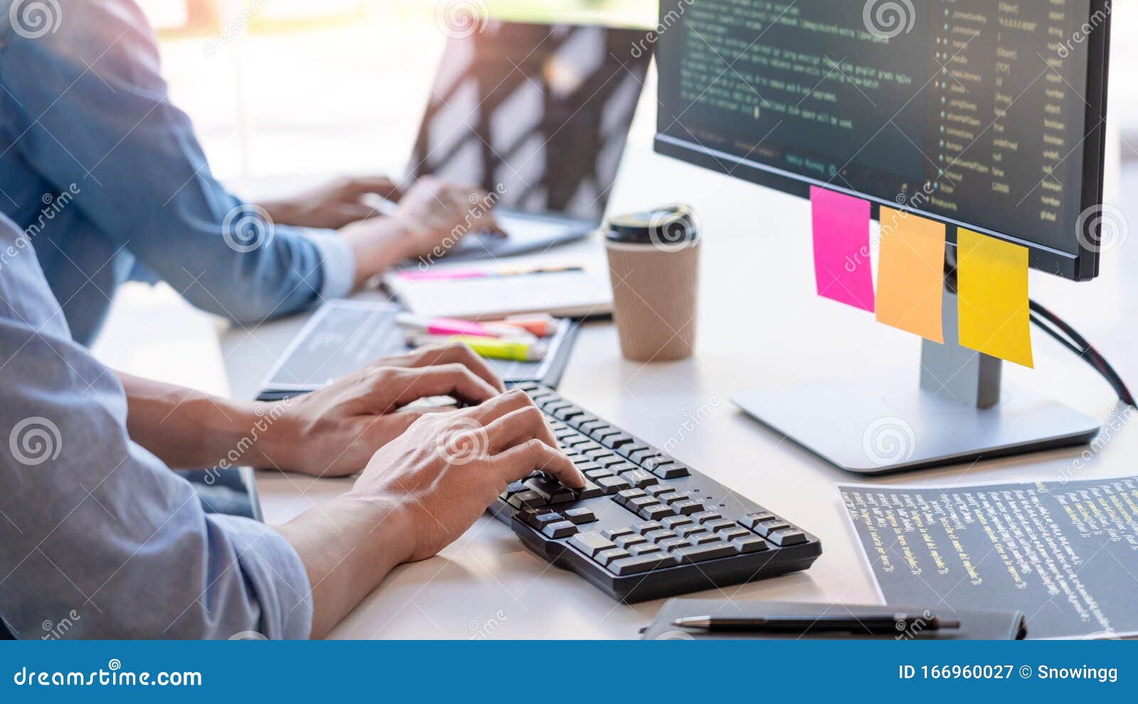 Young Startup Programmers Sitting at Desks Working on Computers Screen ...