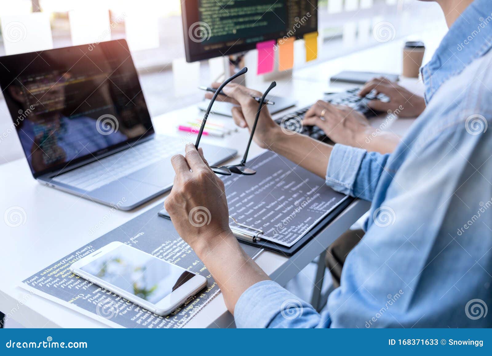 Young Startup Programmers Sitting at Desks Working on Computers Screen ...