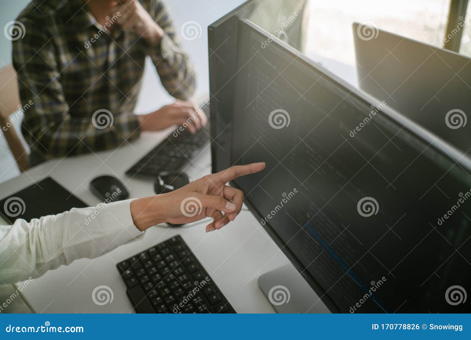 Young Startup Programmers Sitting at Desks Working on Computers Screen ...