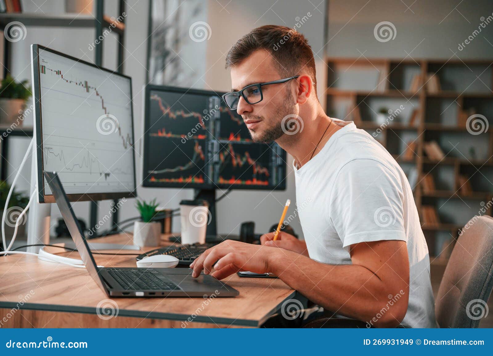 Young Stock Broker is Working in the Office by Using Computer Stock ...