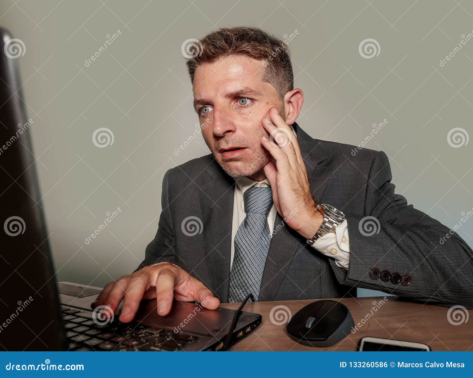 Young Stressed And Overwhelmed Businessman In Suit And Tie Working At