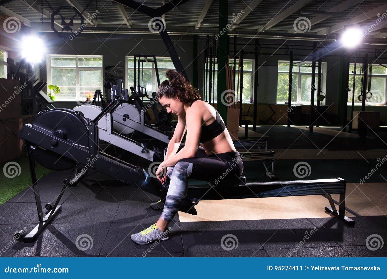 Young Strong Girl Doing an Exercise on a Rowing Machine. for Training ...