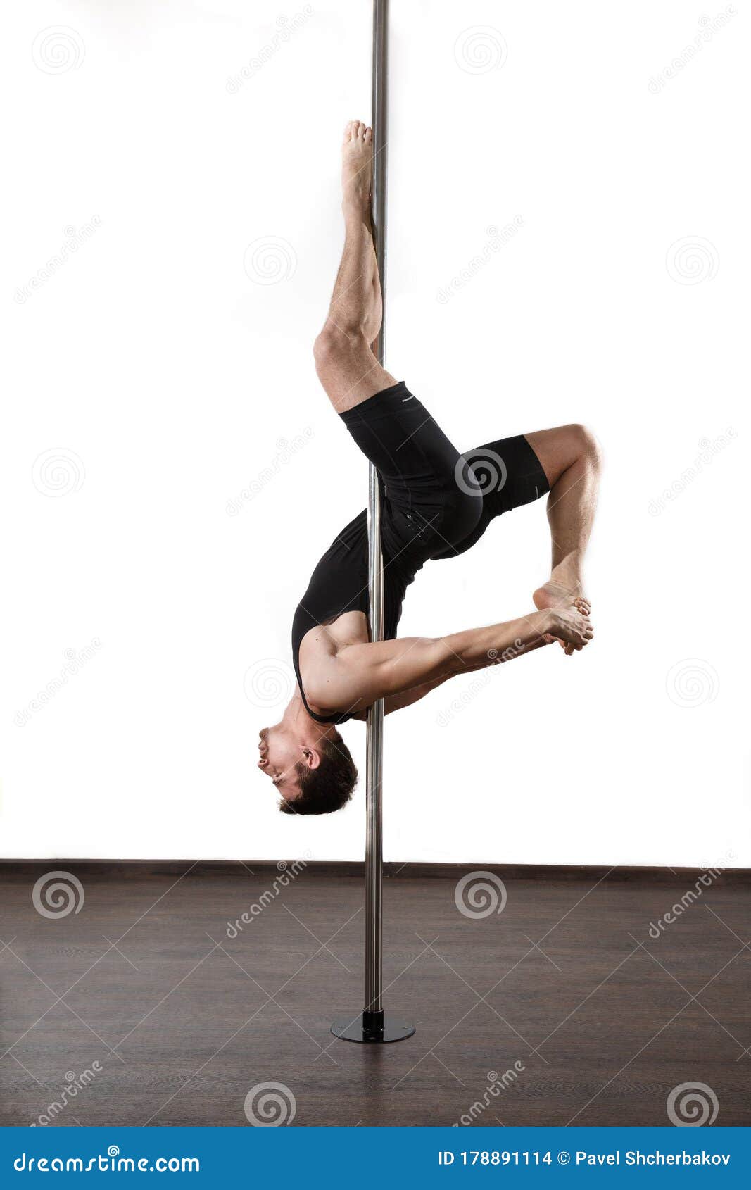 Strong Pole Dancer Smiling Man In Black Clothes On Pylon White