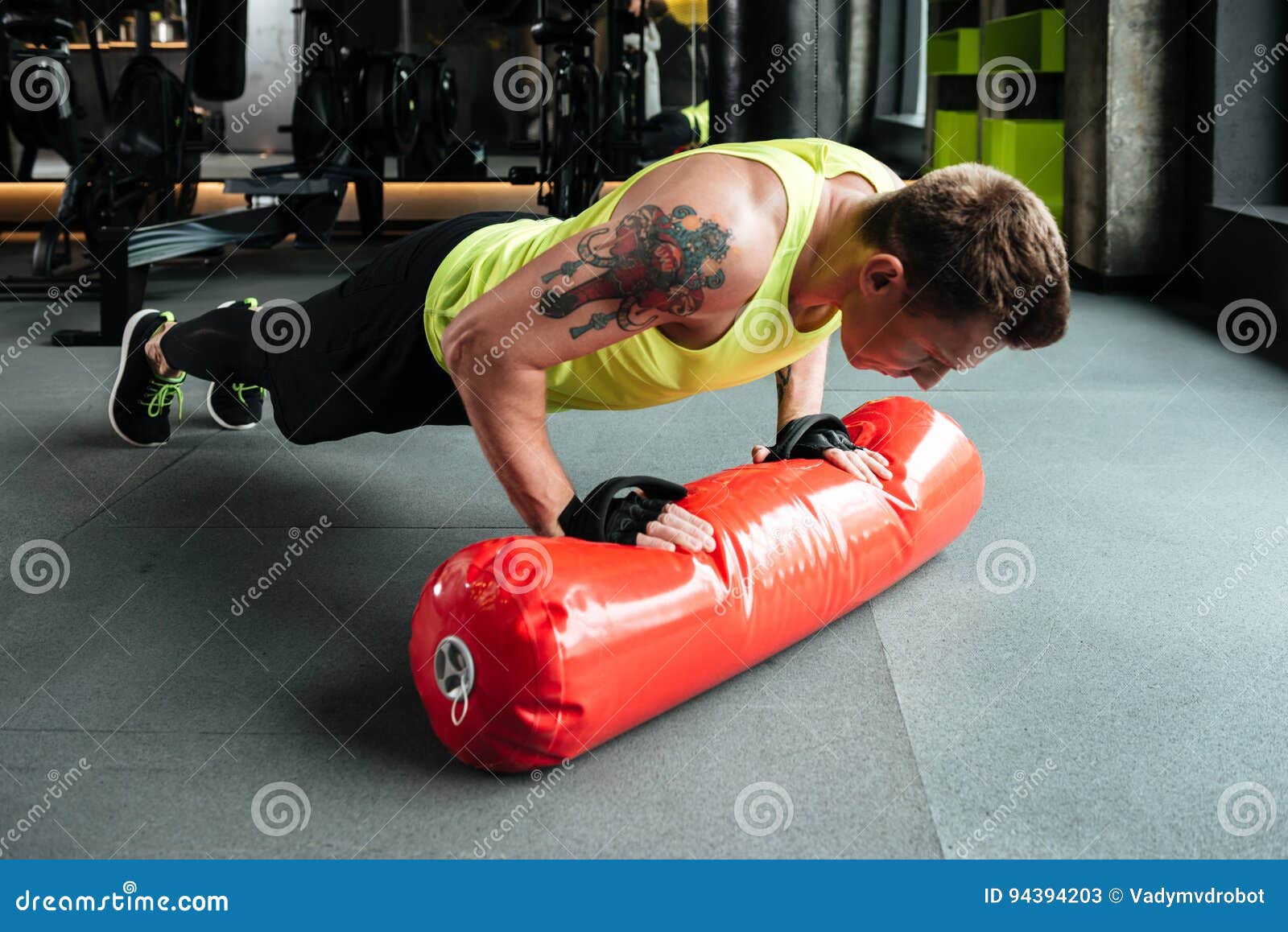Young Strong Sportsman Doing Push Ups and Using Punching Bag Stock ...