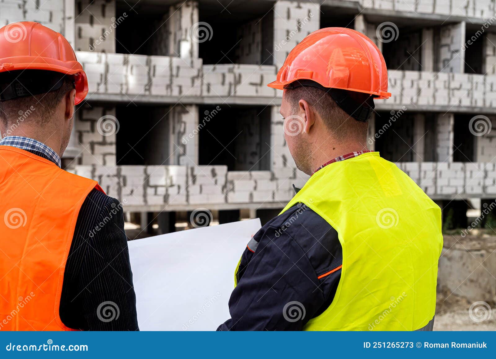 Young Strong Workers in Special Uniforms Compare Construction Work with ...