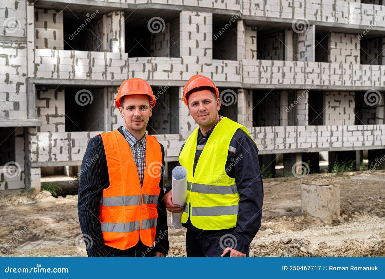Young Strong Workers in Special Uniforms Compare Construction Work with ...