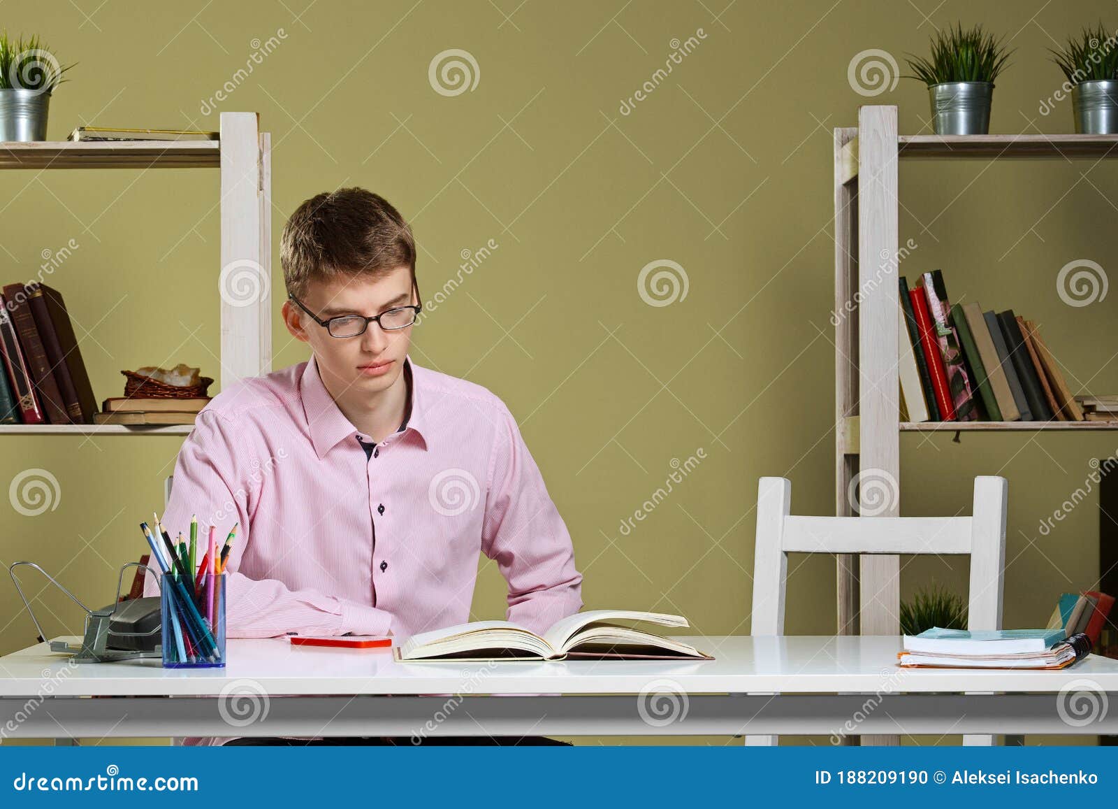Young Student Behind the Desk Reading the Book. Stock Photo - Image of ...