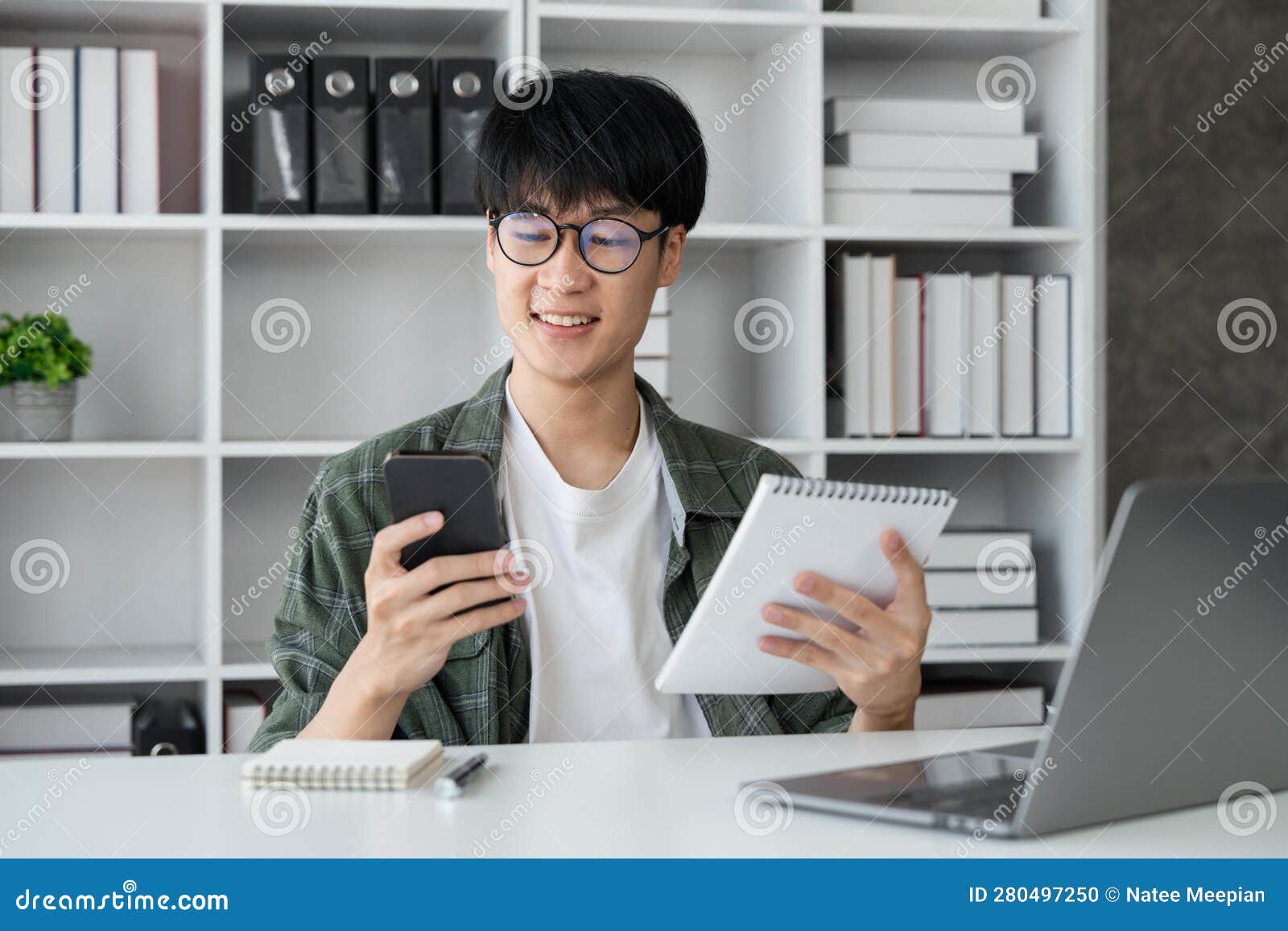 Young Student Busy Study Make Notes in Notebook and Using Laptop ...