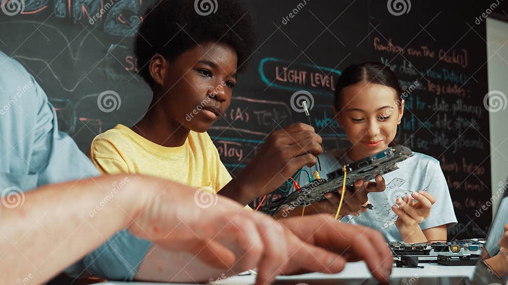 Young Student Fixing Controller while Teacher Programing Code. Edification. Stock Photo - Image ...
