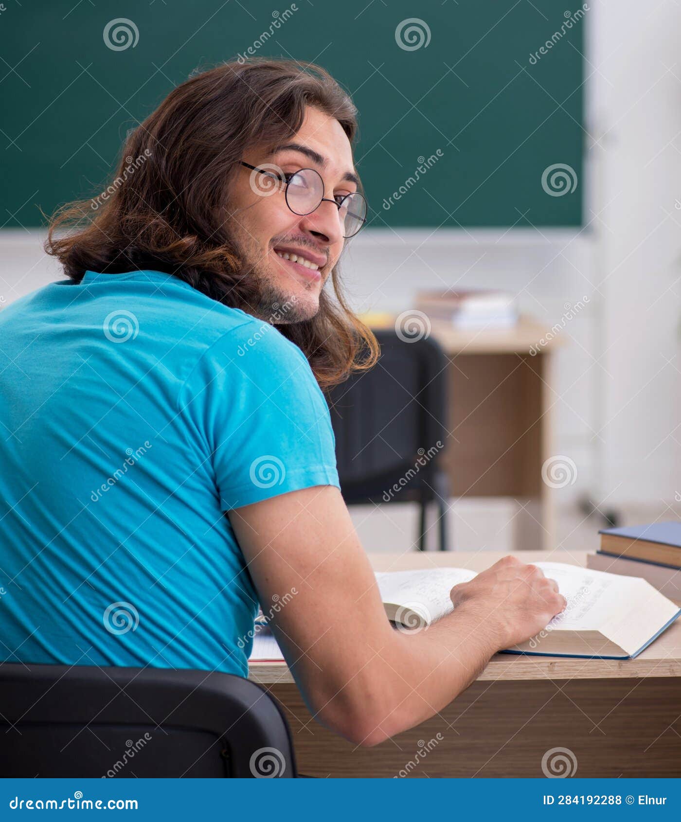 Young Male Student in Front of Green Board Stock Photo - Image of back ...