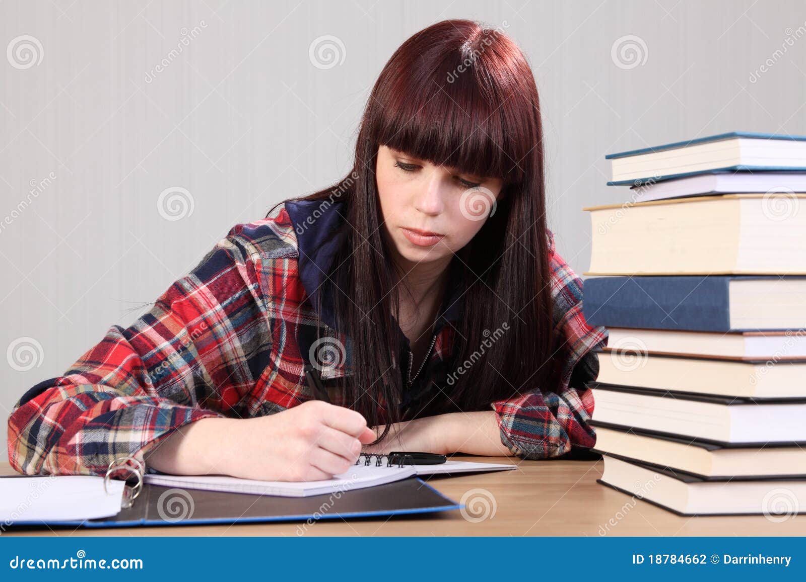 Young Student Girl Doing Homework Writing in Book Stock Photo - Image ...