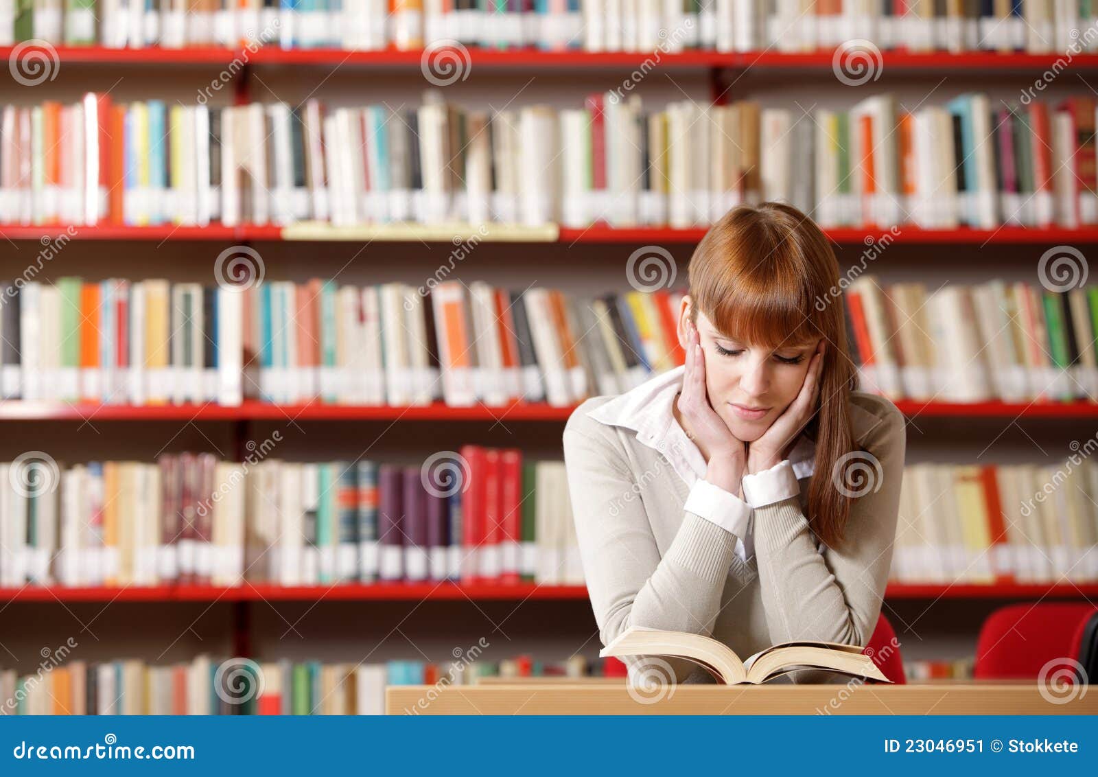 Young student in a library stock image. Image of holding - 23046951