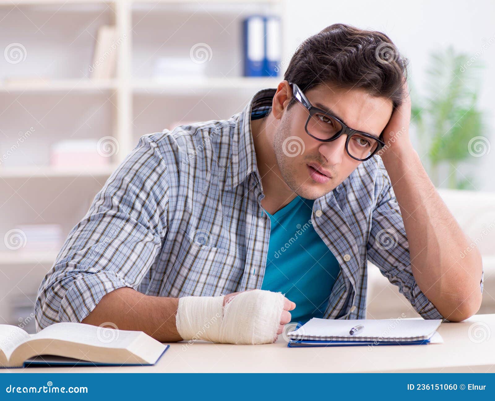 Young Student Man with Hand Injury Preparing for the Exams Stock Photo ...