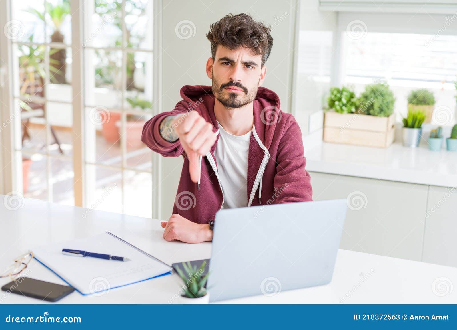 Young Student Man Using Computer Laptop and Notebook with Angry Face ...