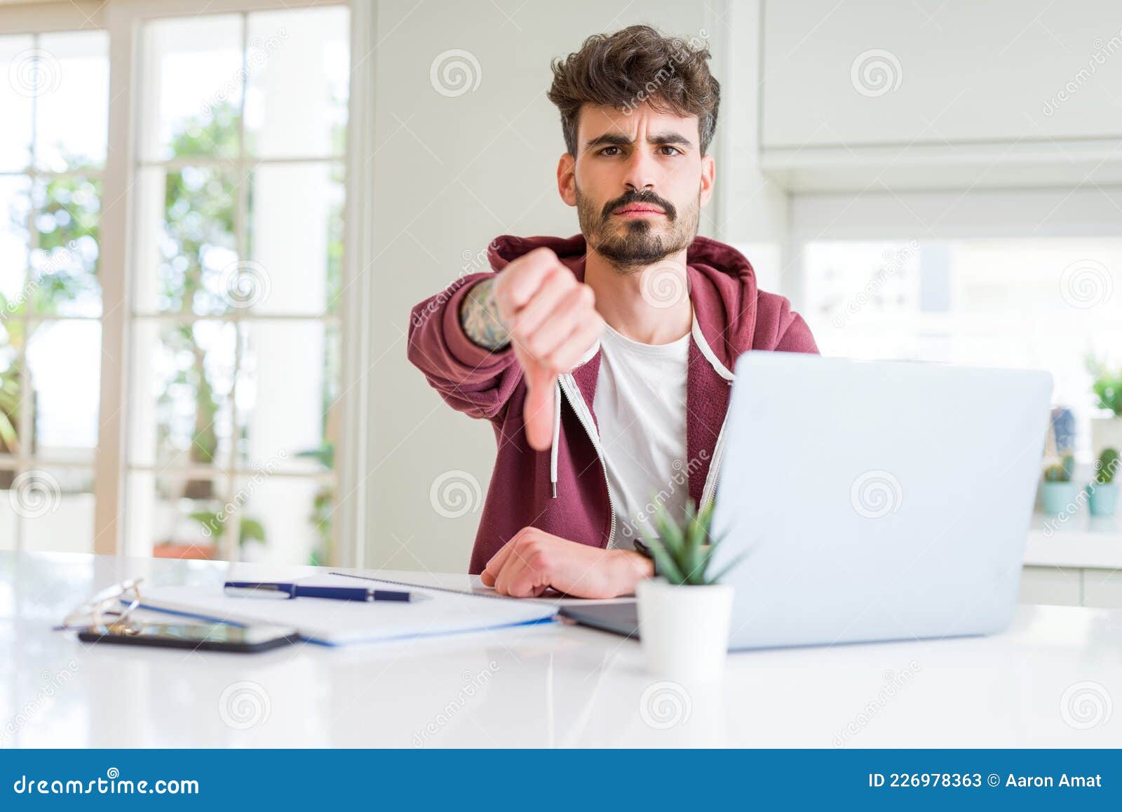 Young Student Man Using Computer Laptop and Notebook with Angry Face ...