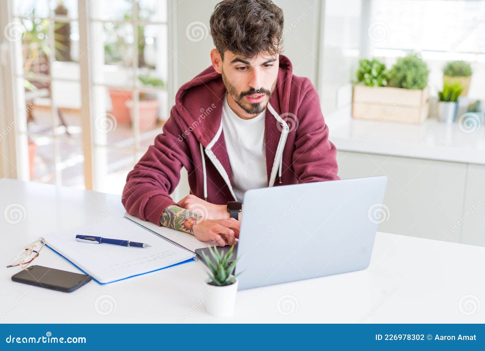 Young Student Man Using Computer Laptop and Notebook Scared in Shock ...