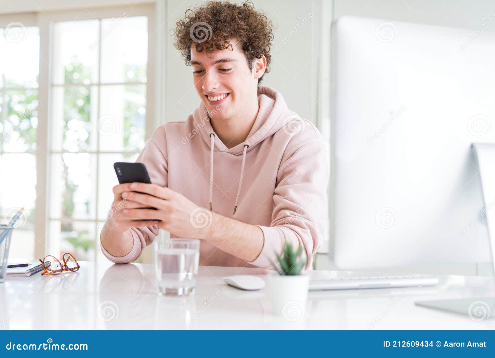 Young Student Man Using Smartphone and Computer with a Happy Face ...