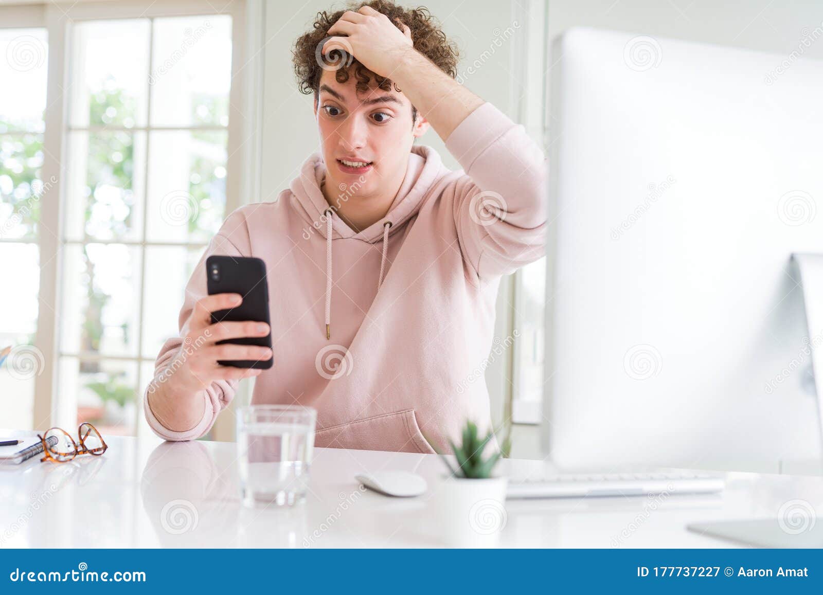 Young Student Man Using Smartphone and Computer Stressed with Hand on ...