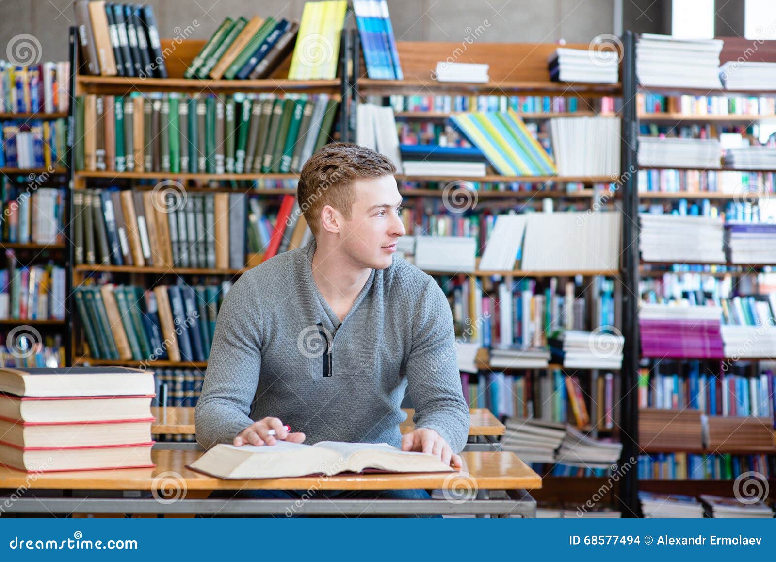 Young Student with Open Book Working in a Library Stock Photo - Image ...