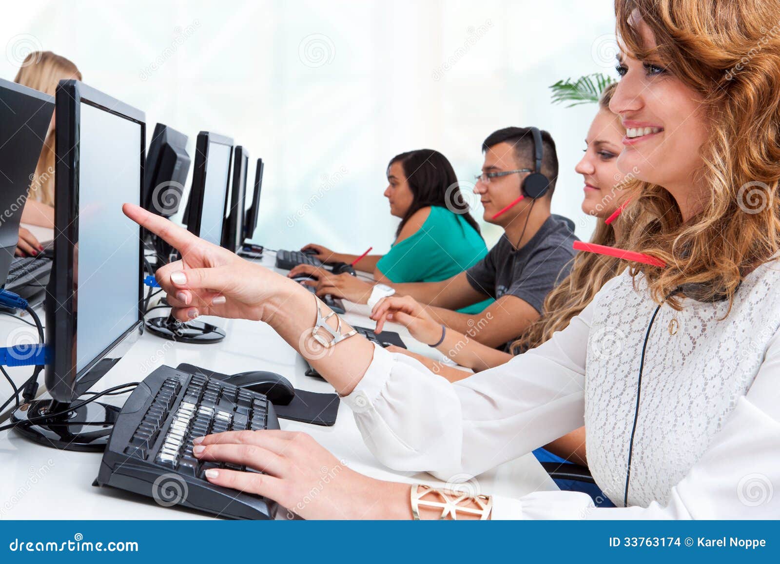 Young Student Pointing with Finger at Computer Screen. Stock Photo ...