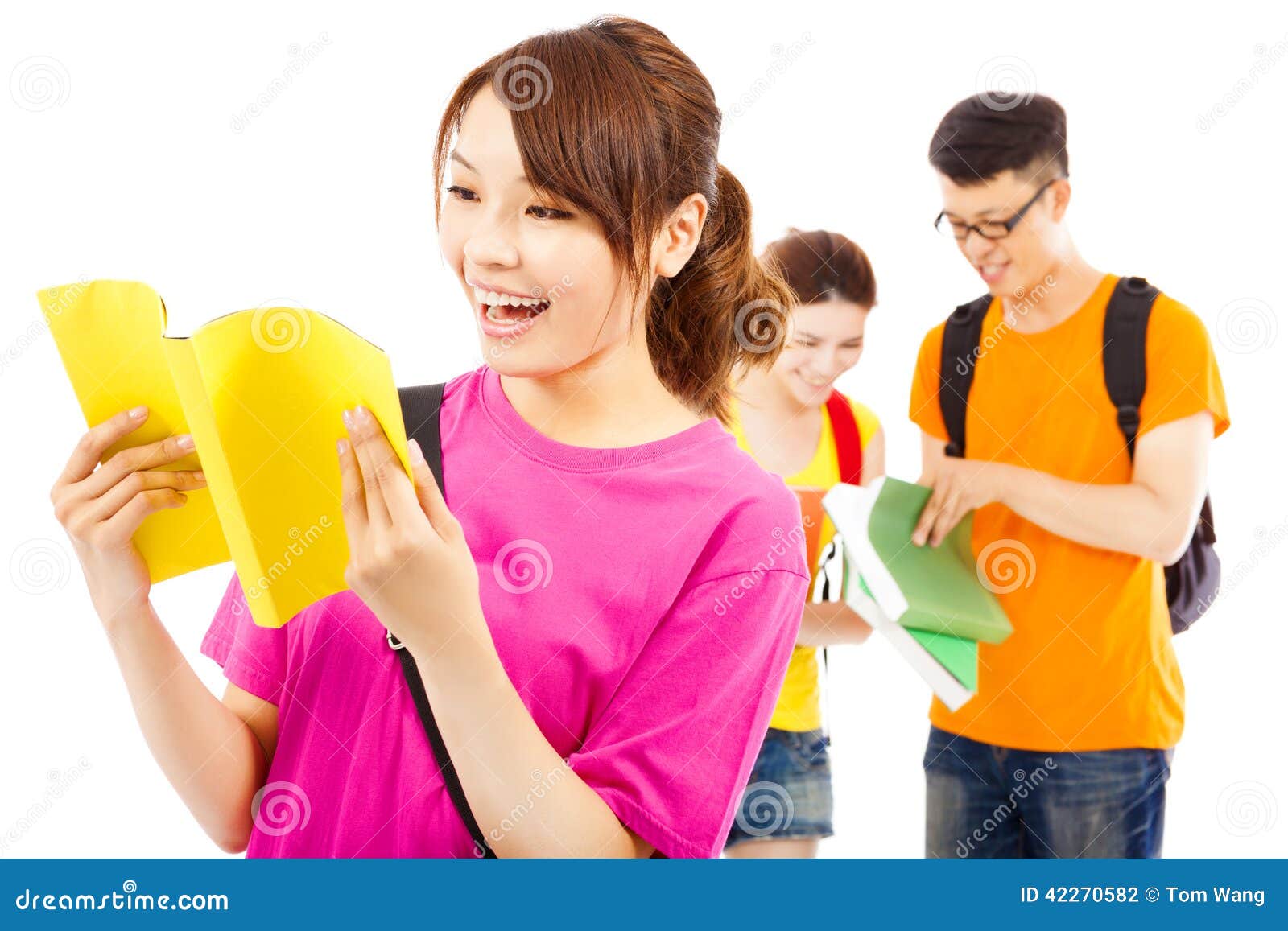 Young Student Reading a Book with Classmates and Laughing Stock Photo ...