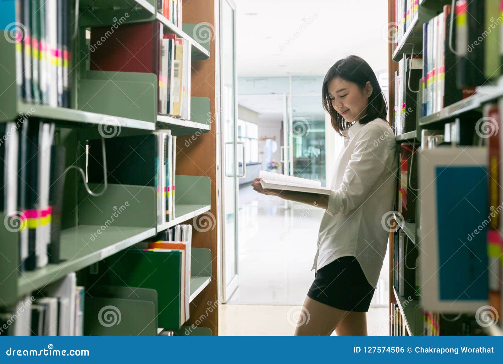 Young Student Reading the Book in Library. Stock Photo - Image of group ...