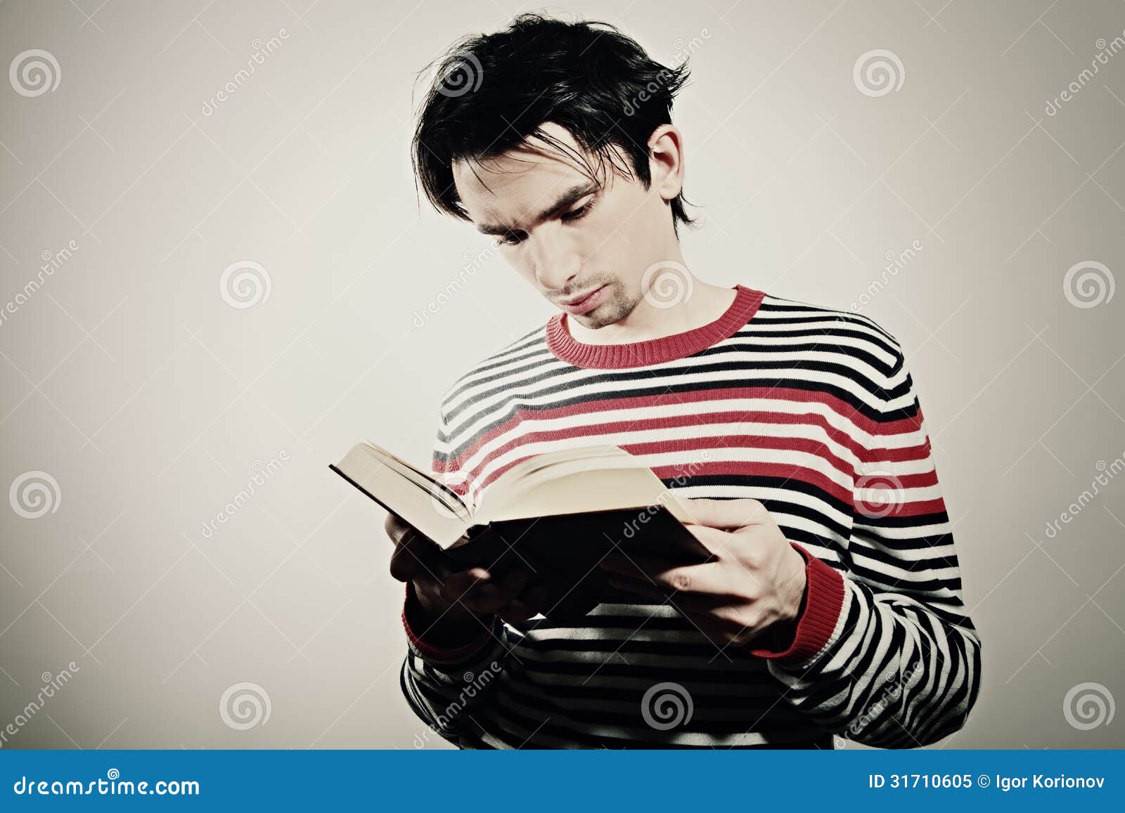 Young Student Reading a Textbook Stock Image - Image of holding ...