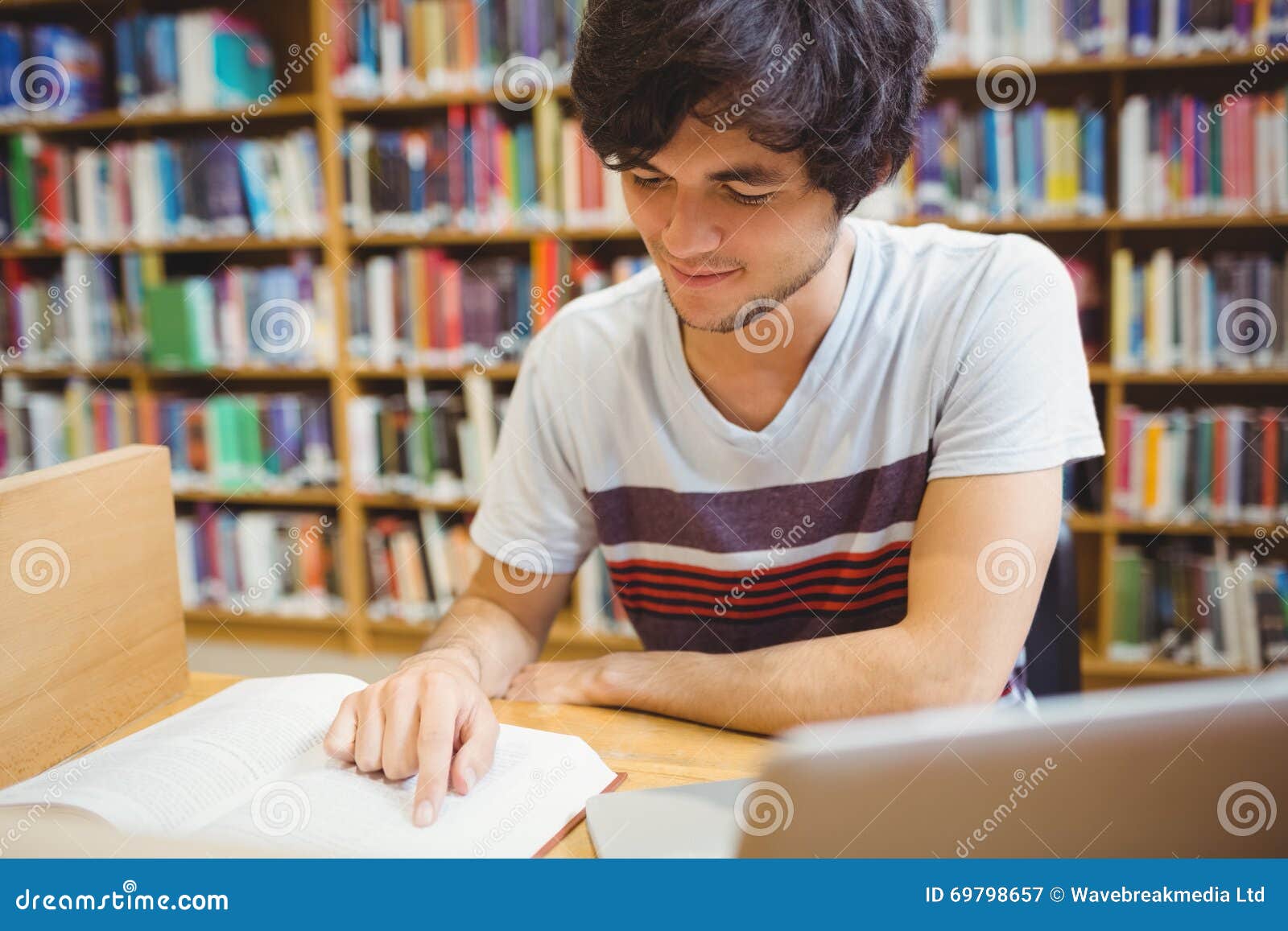 Young Student Sitting at Desk Reading a Book Stock Image - Image of ...