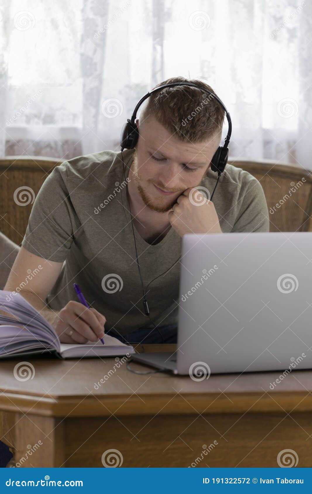 Young Student is Studying at the University Remotely from Home Using a ...