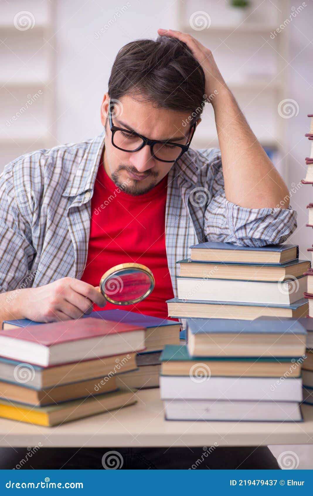 Young Male Student and Too Many Books in the Classroom Stock Image ...