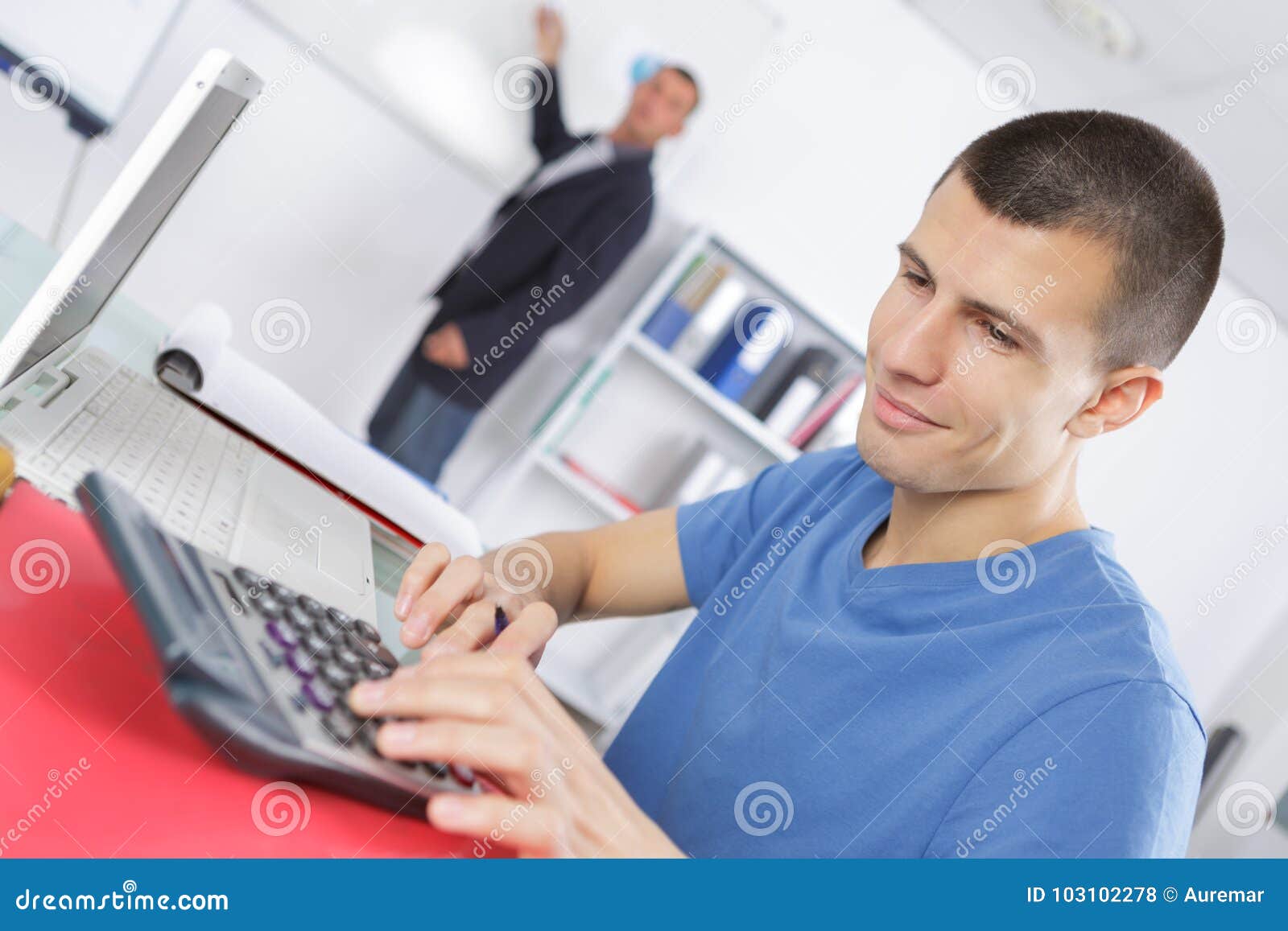 Young Student Using Calculator Stock Photo - Image of background ...
