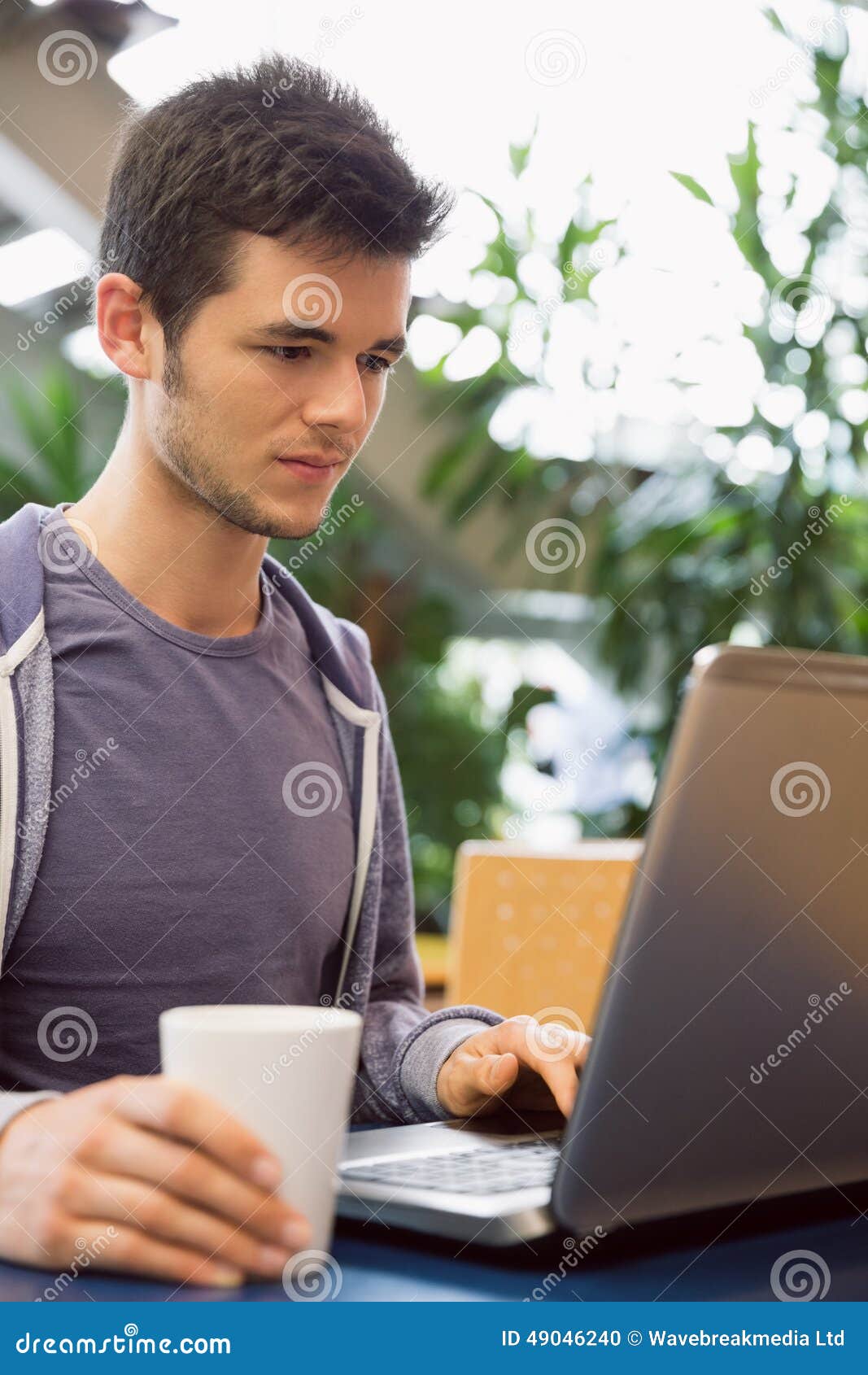 Young Student Using His Laptop in Cafe Stock Photo - Image of ...