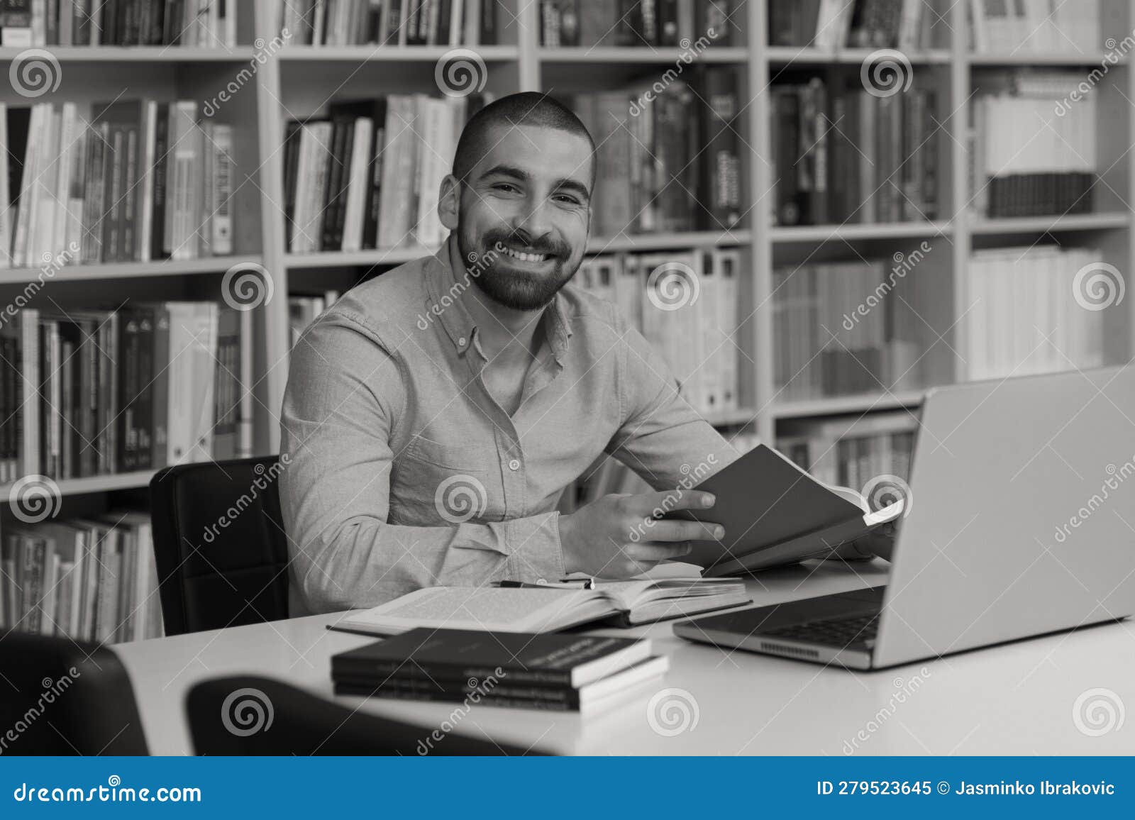 Young Student Using His Laptop in a Library Stock Image - Image of tech ...