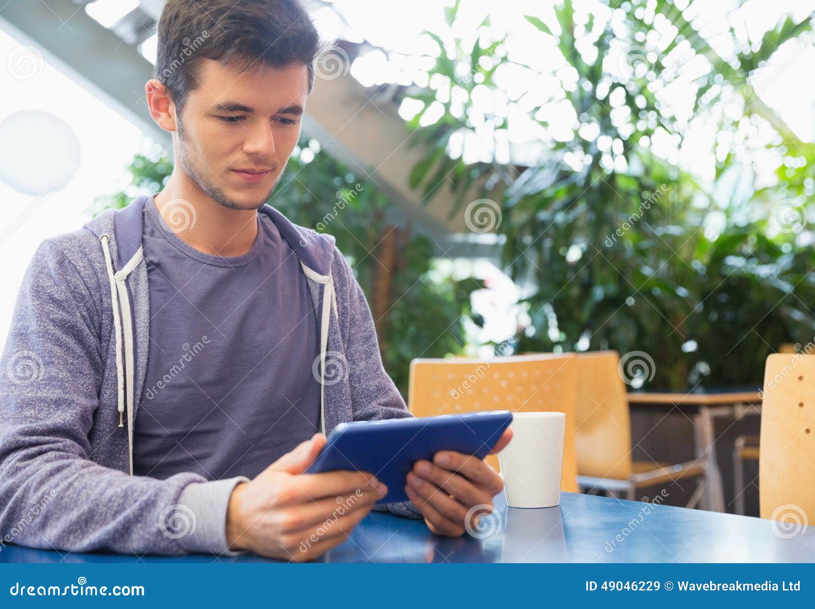 Young Student Using His Tablet in Cafe Stock Image - Image of focus ...