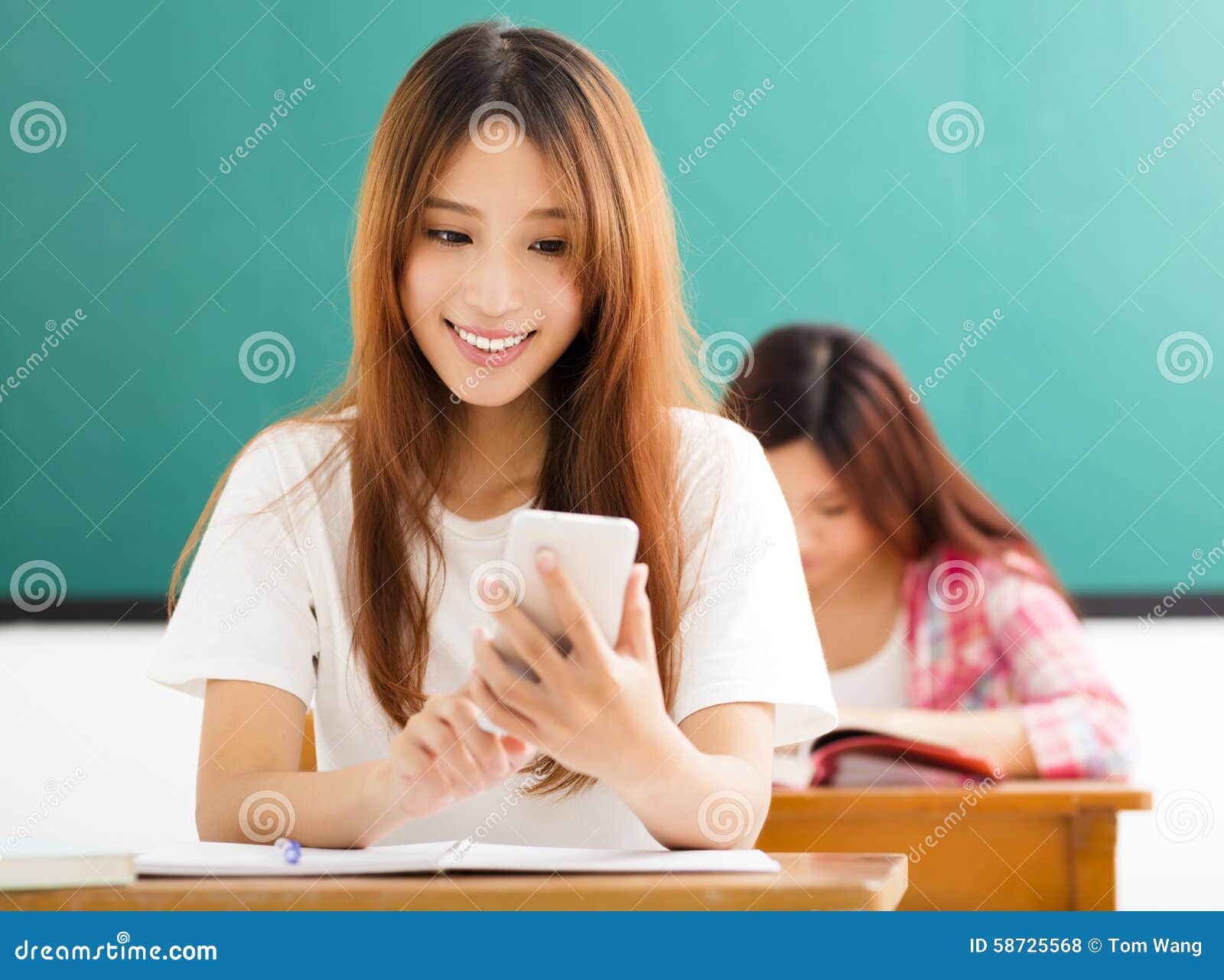 Young Student Using Smart Phone in Classroom Stock Photo - Image of ...