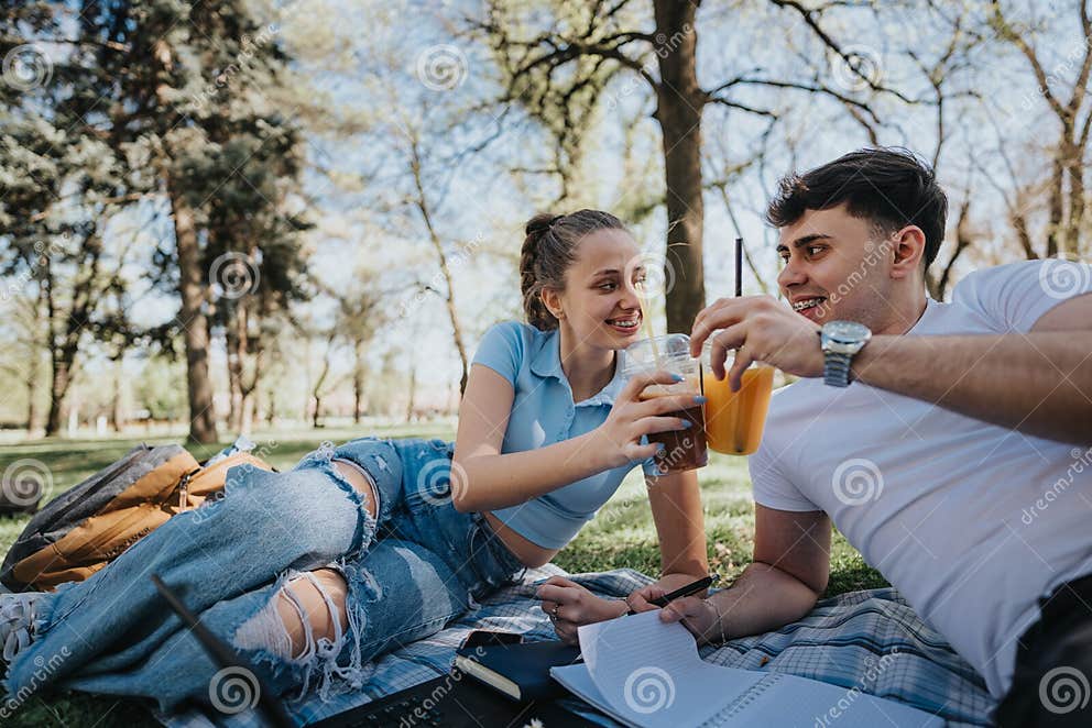 Young Students Enjoy a Refreshing Drink while Studying in the Park Stock Photo - Image of ...