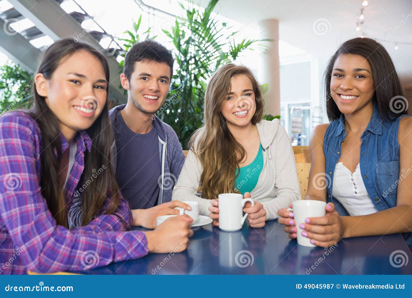 Young Students Having Coffee Together Stock Image - Image of four ...