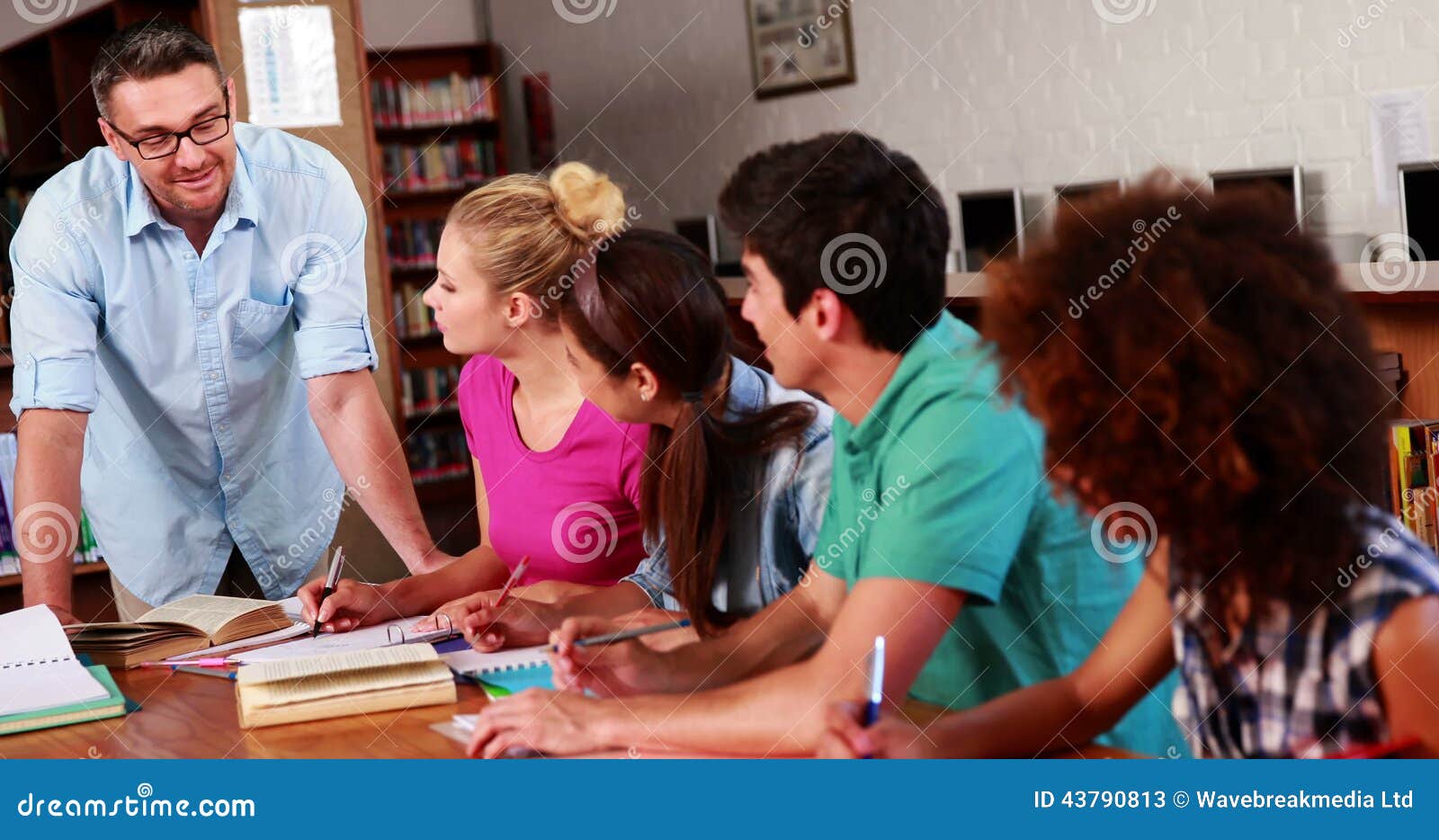 Young Students Revising in the Library with Their Teacher Stock Video ...